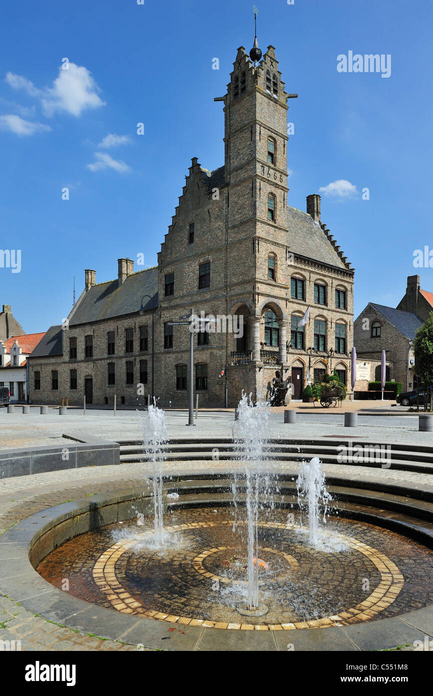 Fountain and old town hall with belfry at Lo, Lo-Reninge, Belgium Stock ...