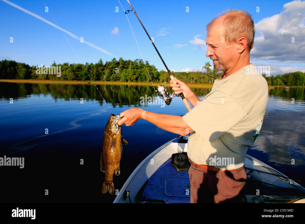 Mature man bass fishing in a lake Stock Photo - Alamy