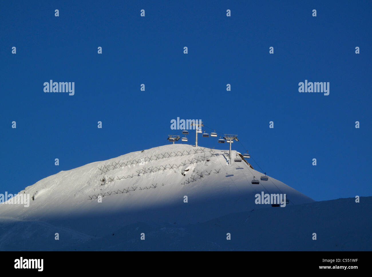 A chair lift over a ski run in the ski resort of Cervinia in the ...