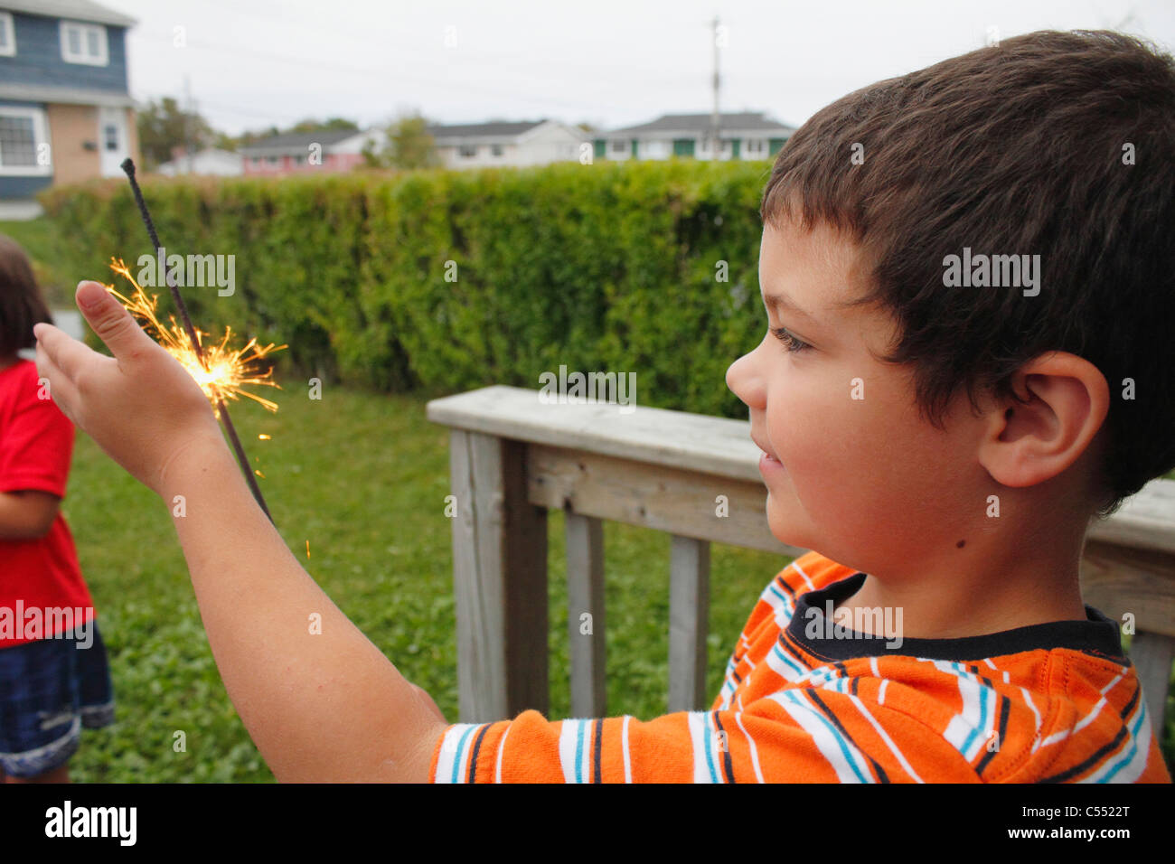 Boy holding a sparkler Stock Photo - Alamy