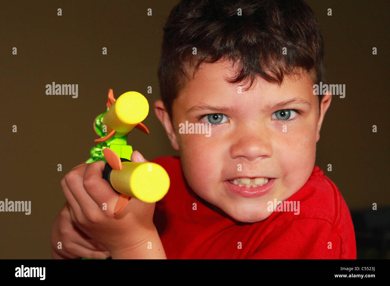 Portrait of a boy aiming with a toy gun Stock Photo - Alamy