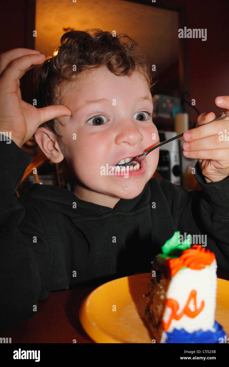 Boy eating birthday cake Stock Photo - Alamy