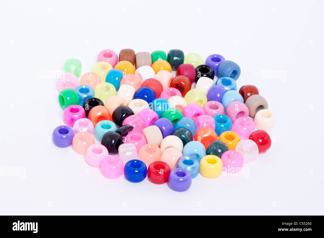 A selection of coloured beads on a white background Stock Photo - Alamy