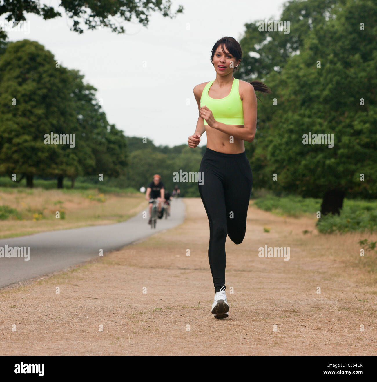 A young latino woman running in Richmond Park, London Stock Photo - Alamy