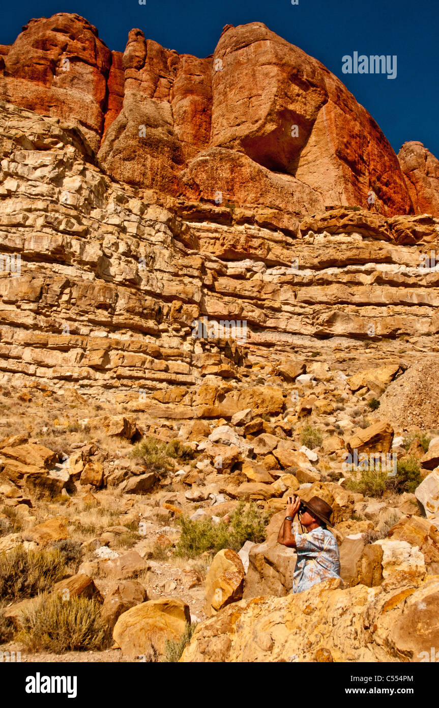 Man observing Parowan Gap Petroglyphs listed on the National Register ...