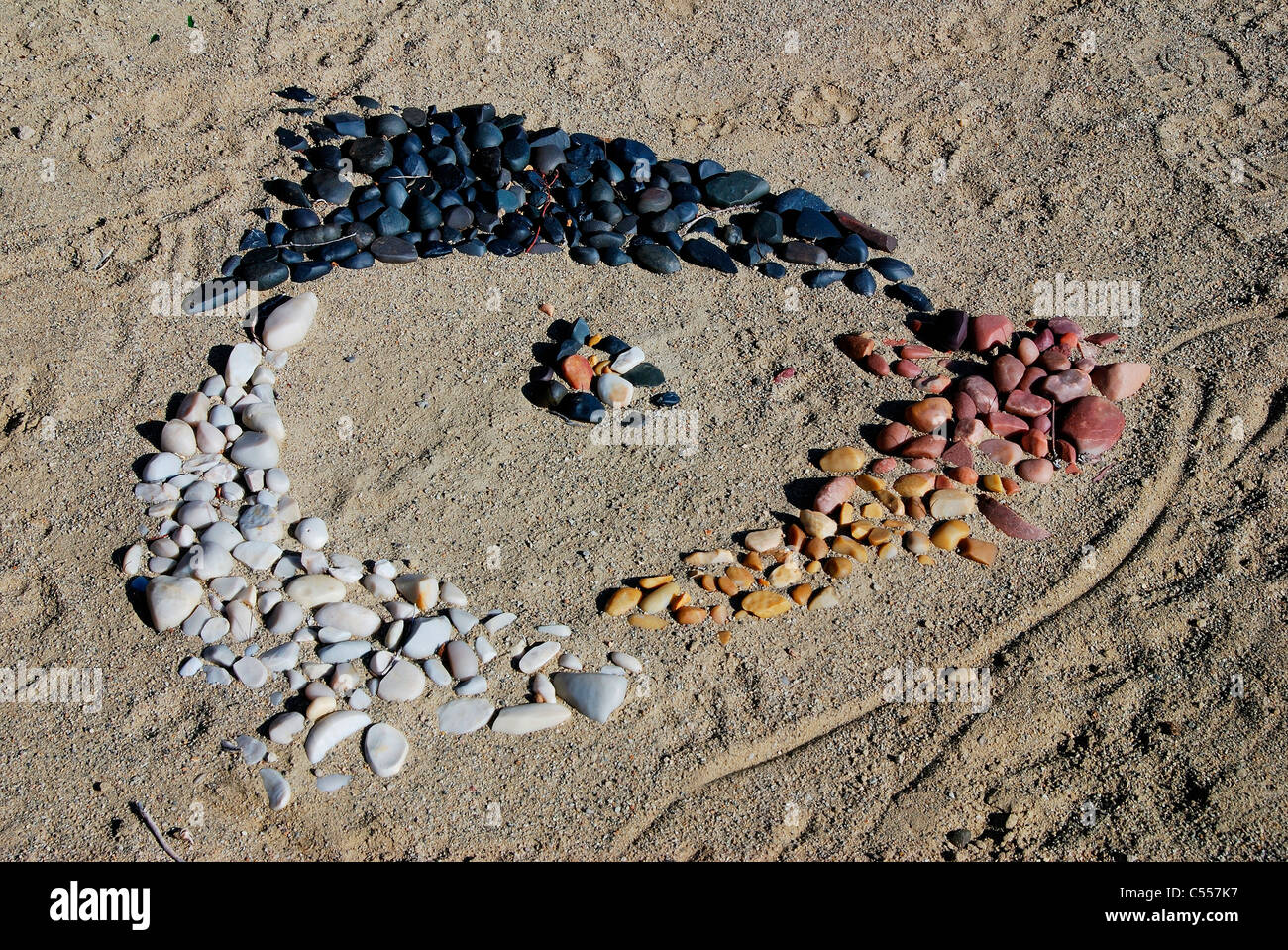 USA, Wyoming, Wind River Indian Reservation, pebbles arranged on sand ...
