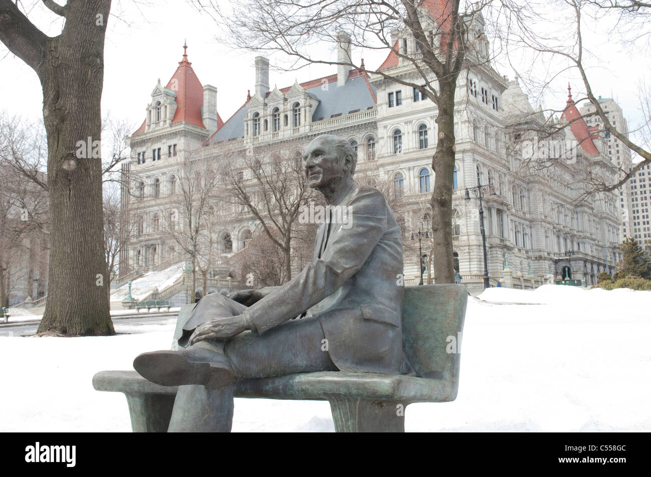 Statue of Lewis Swyer in a park with a government building in the ...