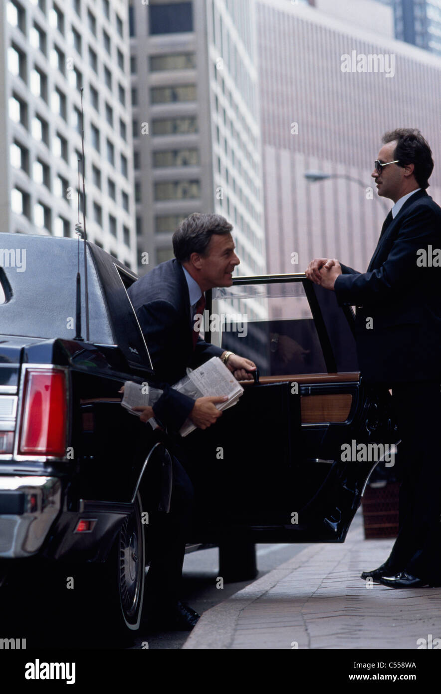 Chauffeur opening limousine door hi-res stock photography and images ...