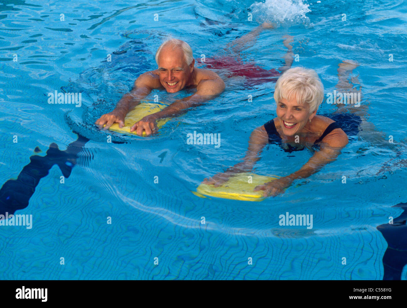 Senior couple swimming in swimming pool Stock Photo - Alamy