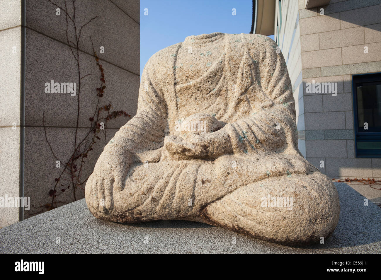 Headless stone statue of Buddha in a museum, Gyeongju National Museum ...