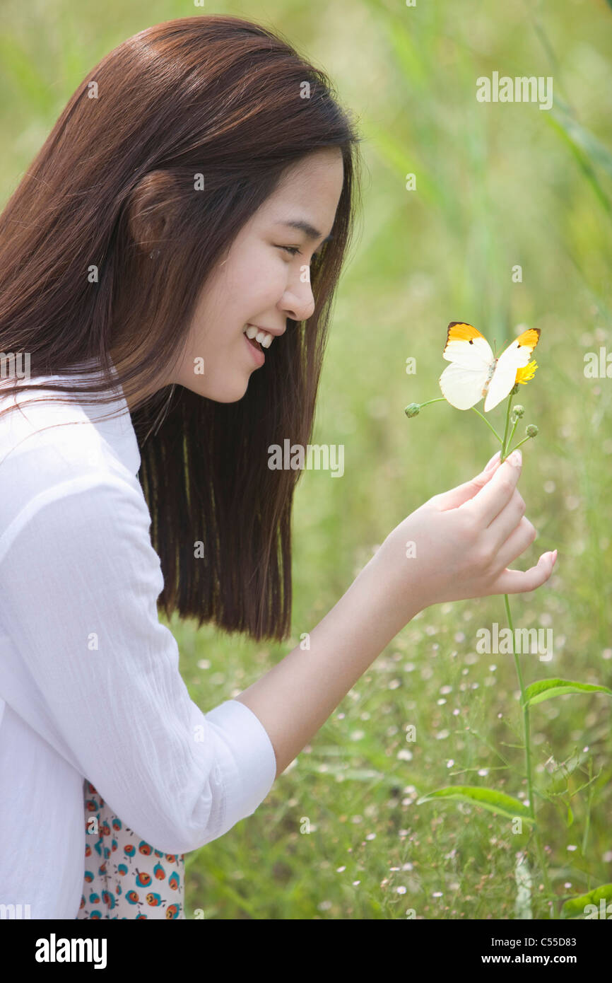 woman is looking at butterfly Stock Photo - Alamy