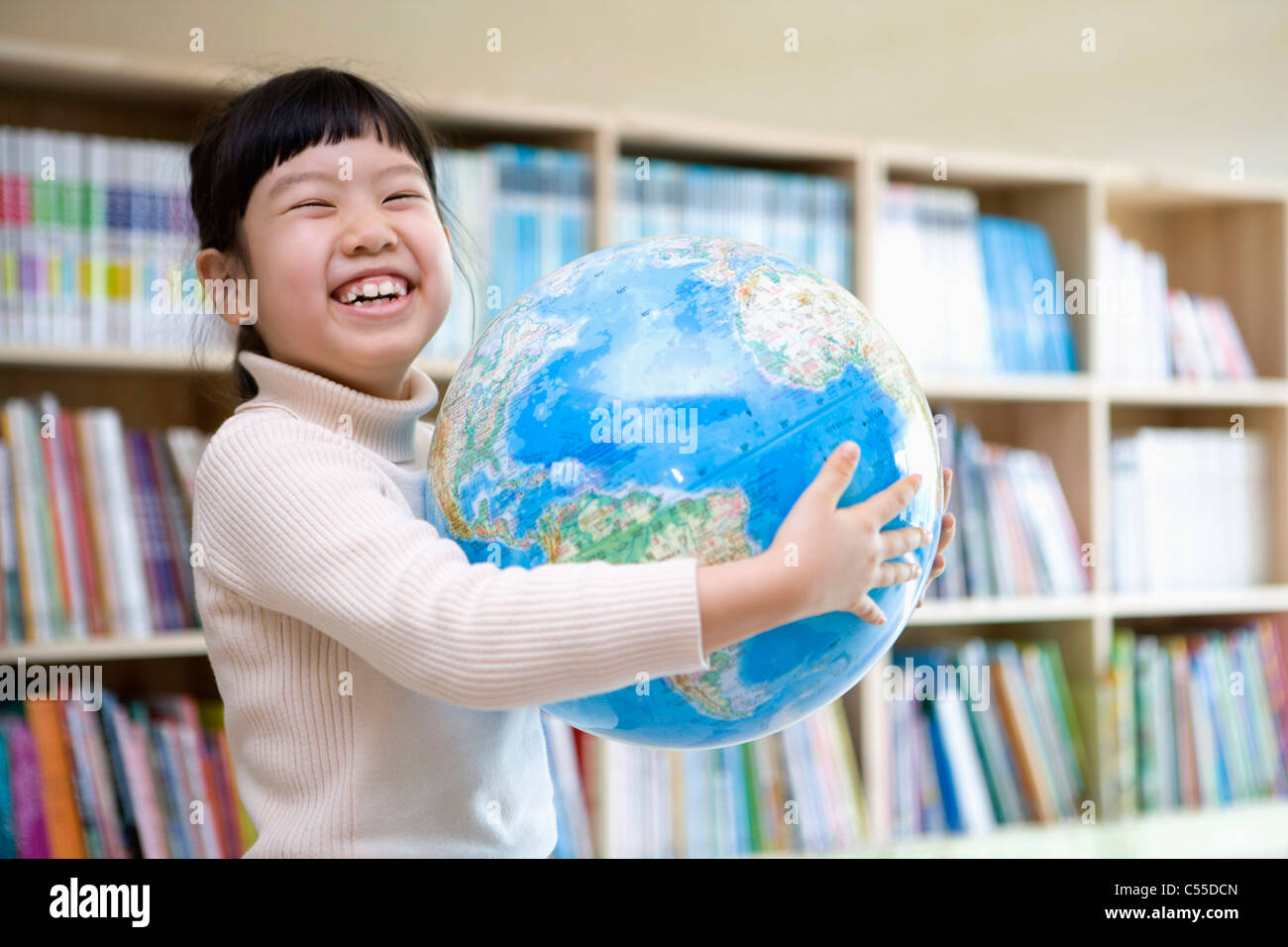 girl hugging globe with a big smile Stock Photo - Alamy