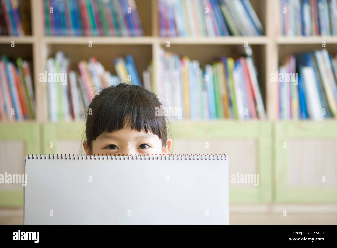 girl hiding herself from sketch book Stock Photo - Alamy