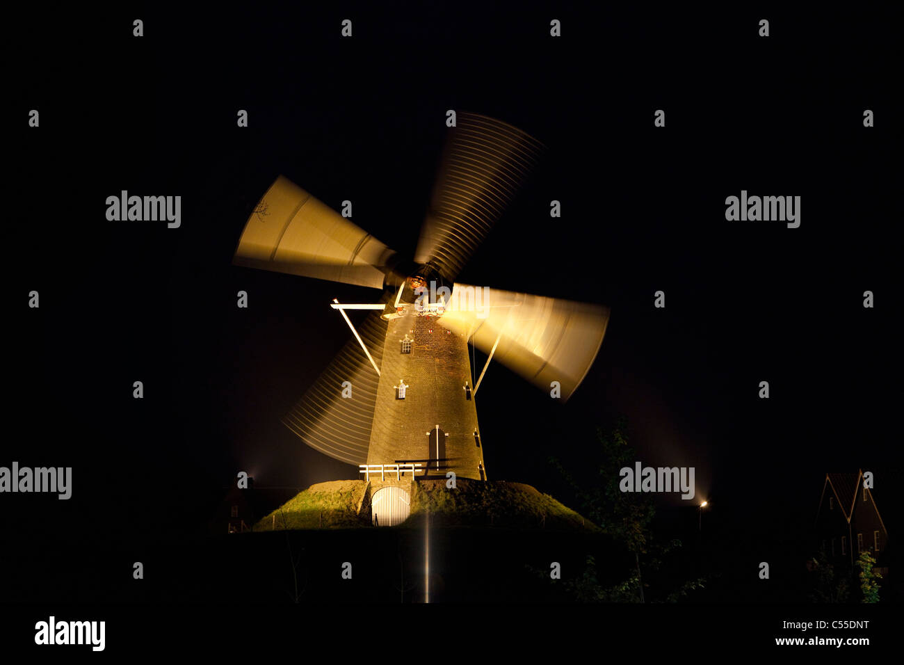 The Netherlands, Bredevoort, Windmill at night moving in floodlight ...