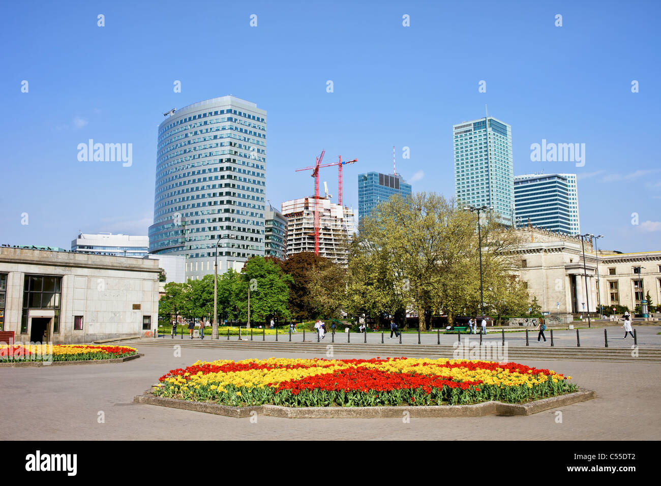 City center of Warsaw in Poland, square with flowerbed and modern ...