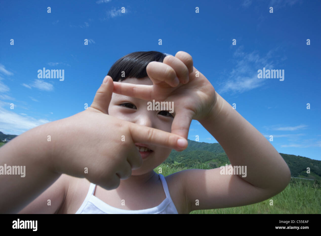 A girl making a square with her fingers Stock Photo - Alamy