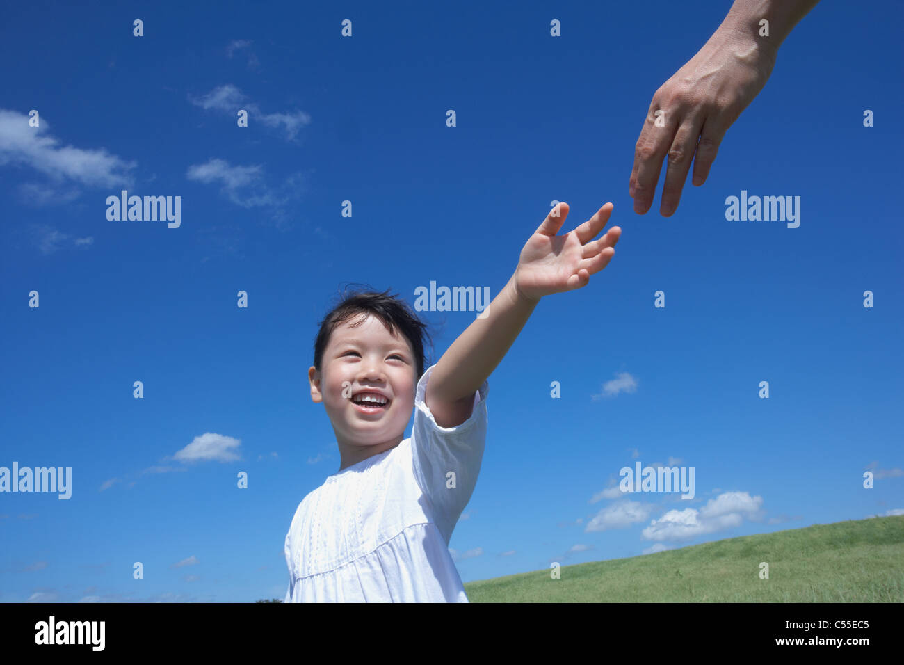 A girl holding out her hand Stock Photo - Alamy