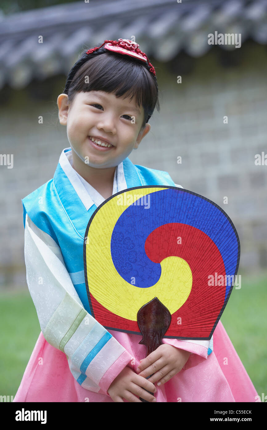 An Asian girl holding a traditional fan Stock Photo - Alamy