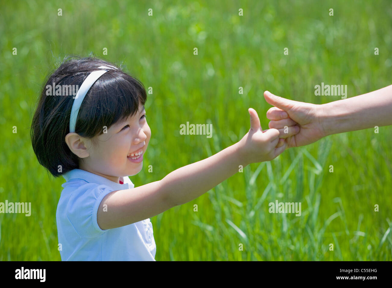 A girl making a Pinkie swear Stock Photo - Alamy