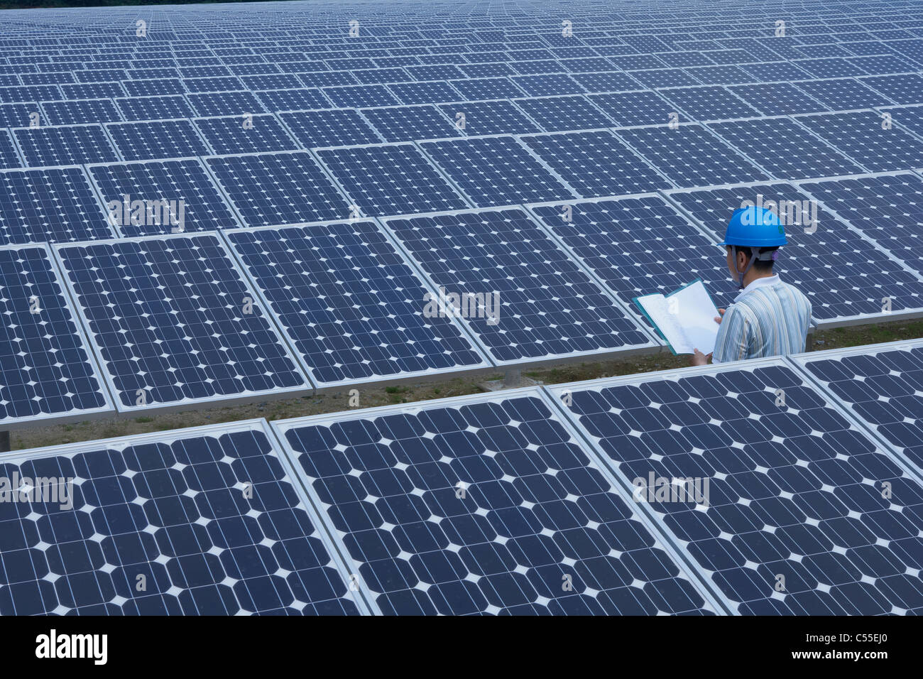 Solar power plant with a person Stock Photo - Alamy
