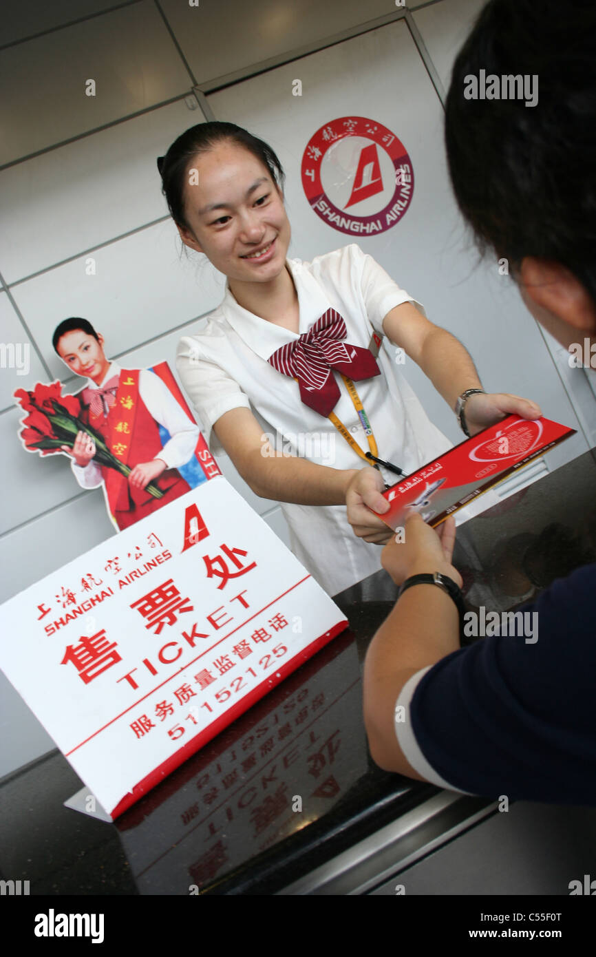 Shanghai Airlines check in ticket staff Pudong Stock Photo - Alamy