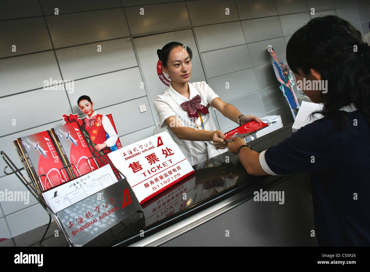 Shanghai Airlines check in ticket staff Pudong Stock Photo - Alamy
