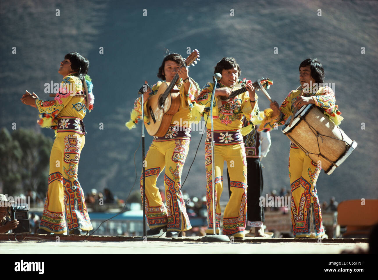 Peru, Cuzco, entertainment group in yellow costumes performing on stage ...