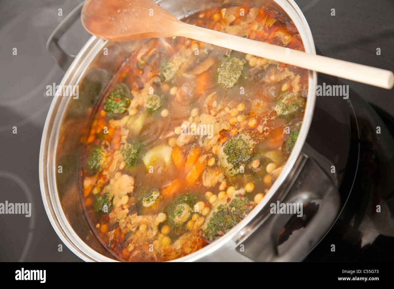 Boiling casserole of soup on a stove Stock Photo - Alamy