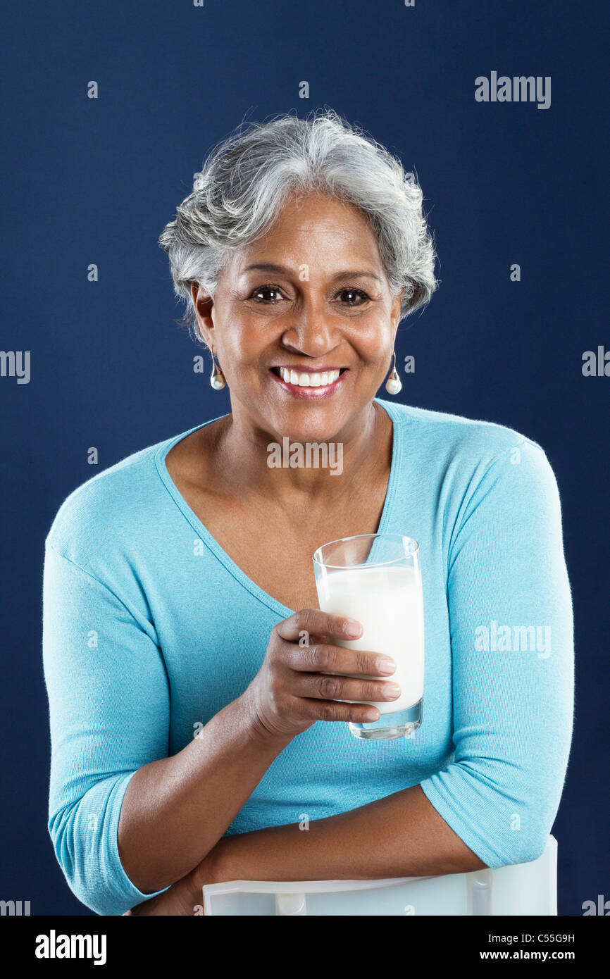 Portrait of a senior woman drinking milk Stock Photo - Alamy