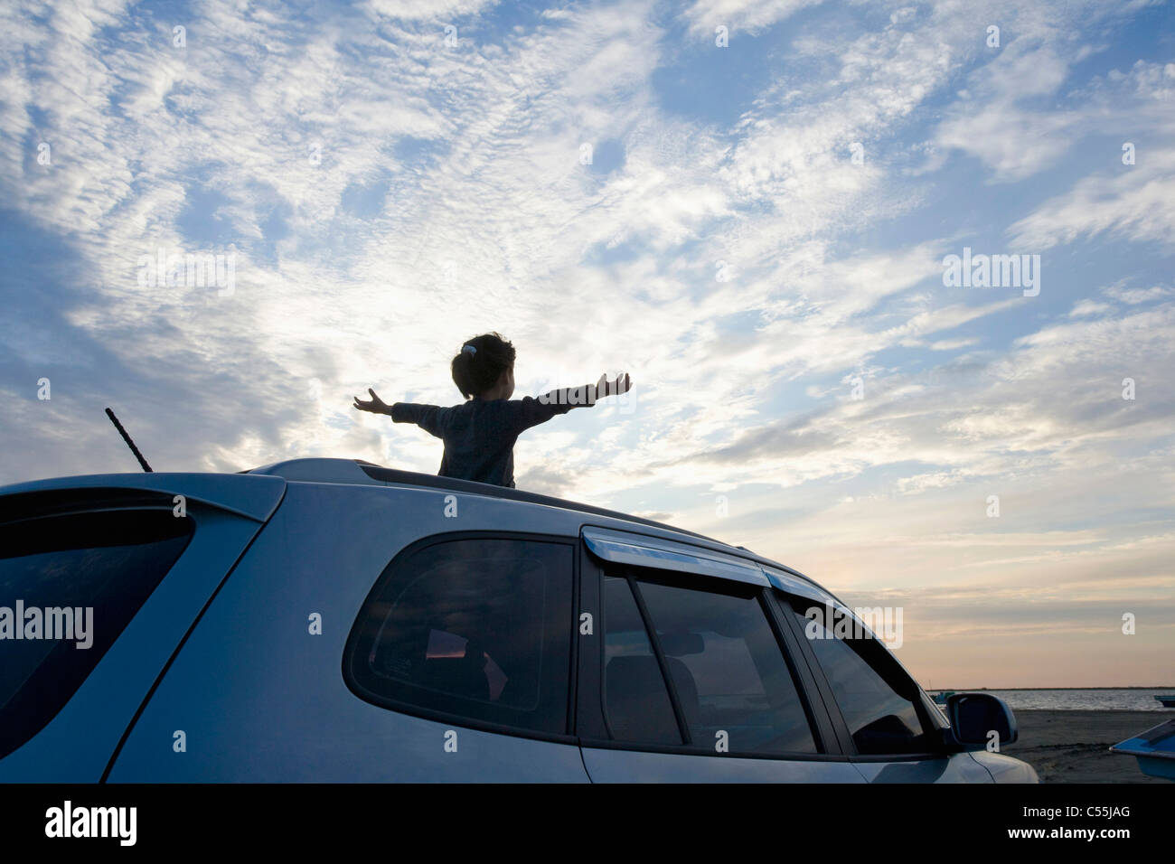 girl out from sun roof Stock Photo - Alamy