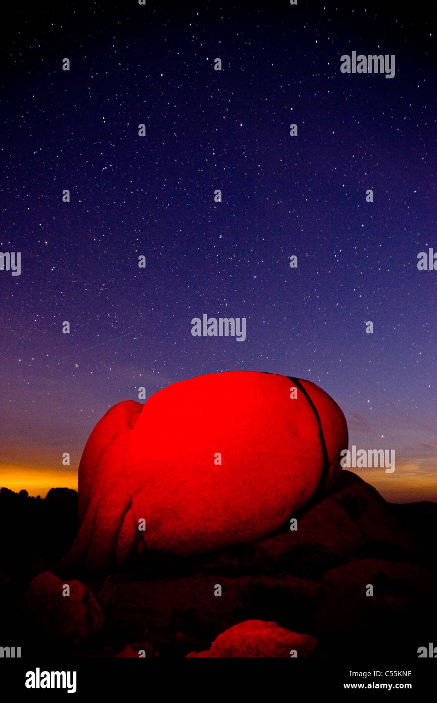 Red light on a boulder at night, Joshua Tree National Monument ...
