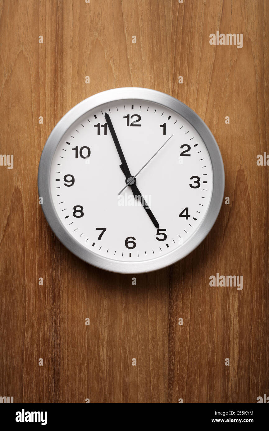 The aluminum wall clock is almost five Stock Photo - Alamy