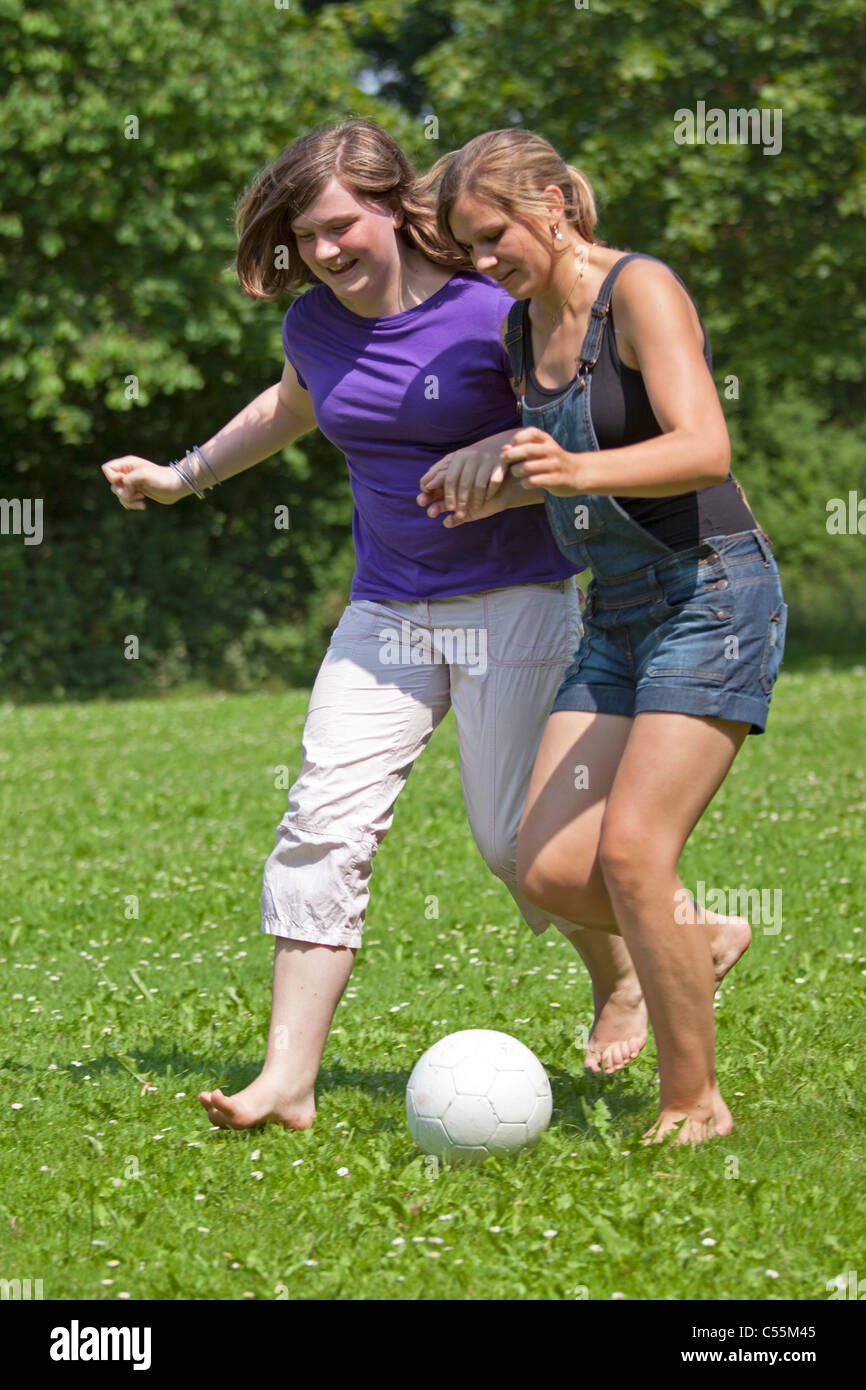 two young girls playing football Stock Photo - Alamy