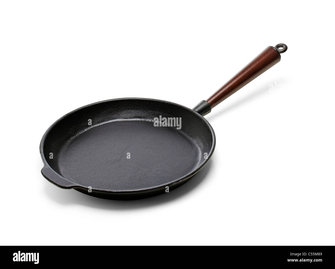 A Traditional cast iron frying pan isolated on white with natural ...