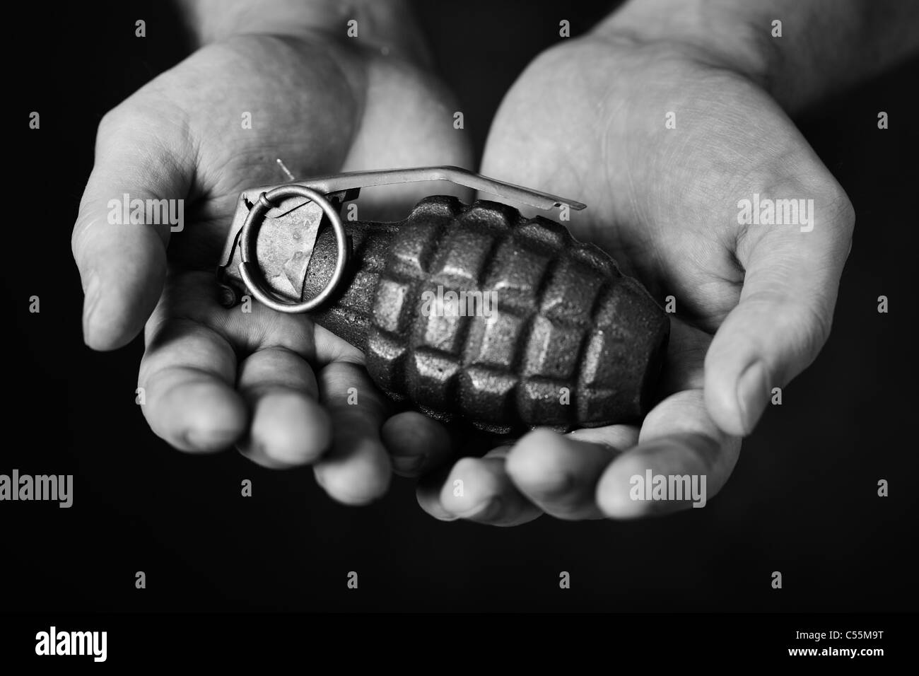 Man holding an old hand grenade in his hands Stock Photo - Alamy