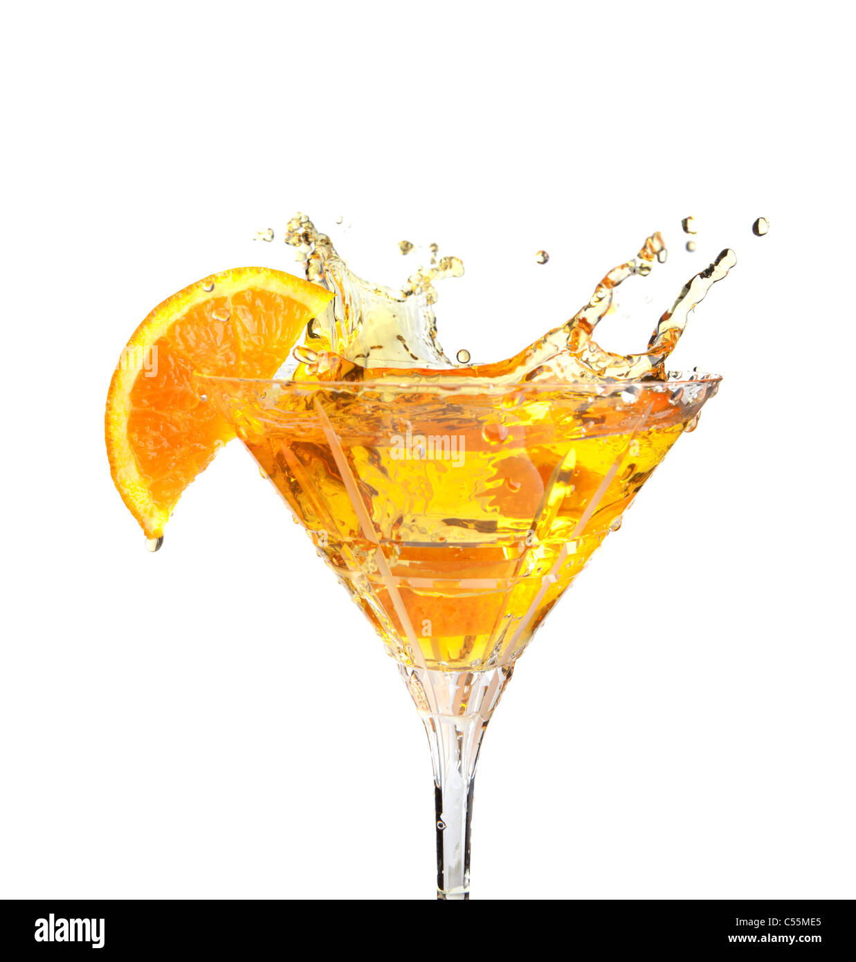 Orange cocktail with splashes and fruit decoration Stock Photo - Alamy