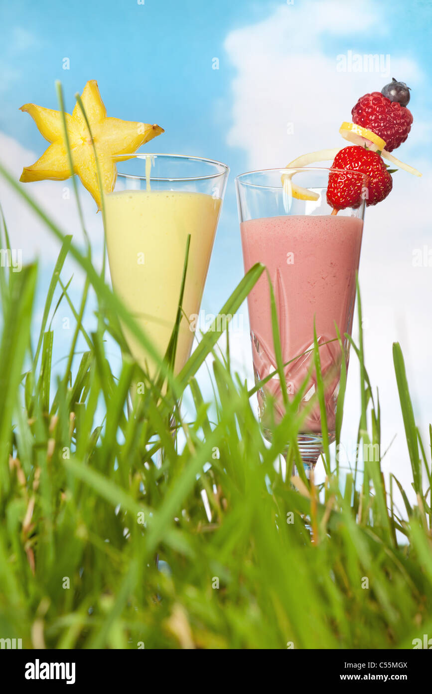 Two pastel colored fruit smoothies in the garden Stock Photo - Alamy
