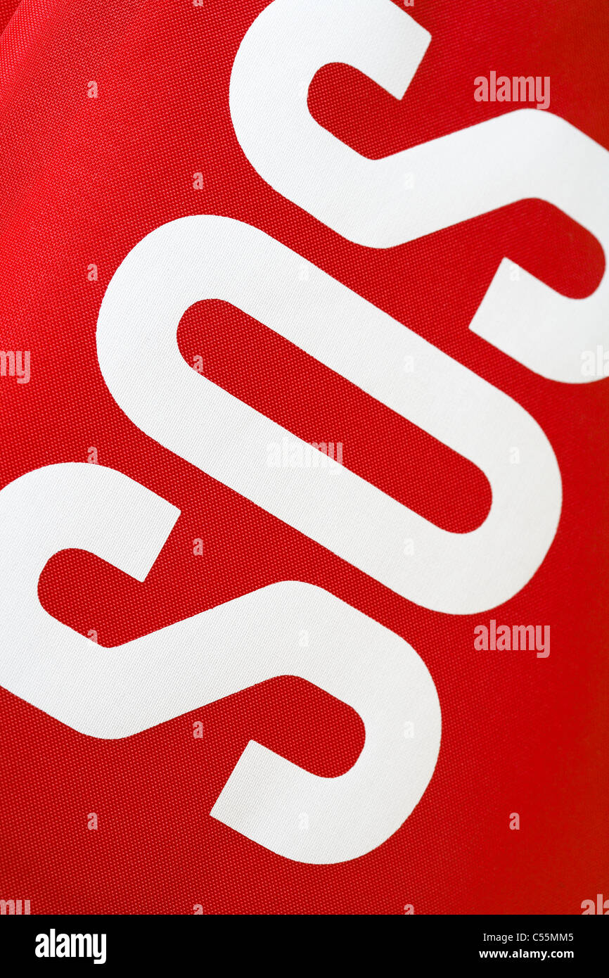 SOS ("save our souls") lettering on a red fabric first aid kit Stock ...