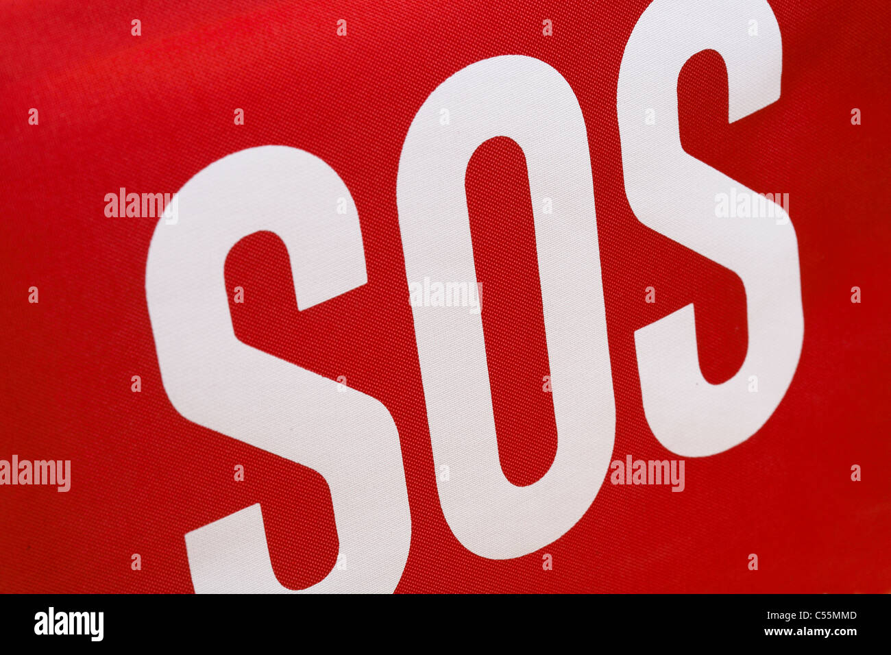 SOS - save our souls - text on red fabric emergency kit Stock Photo - Alamy