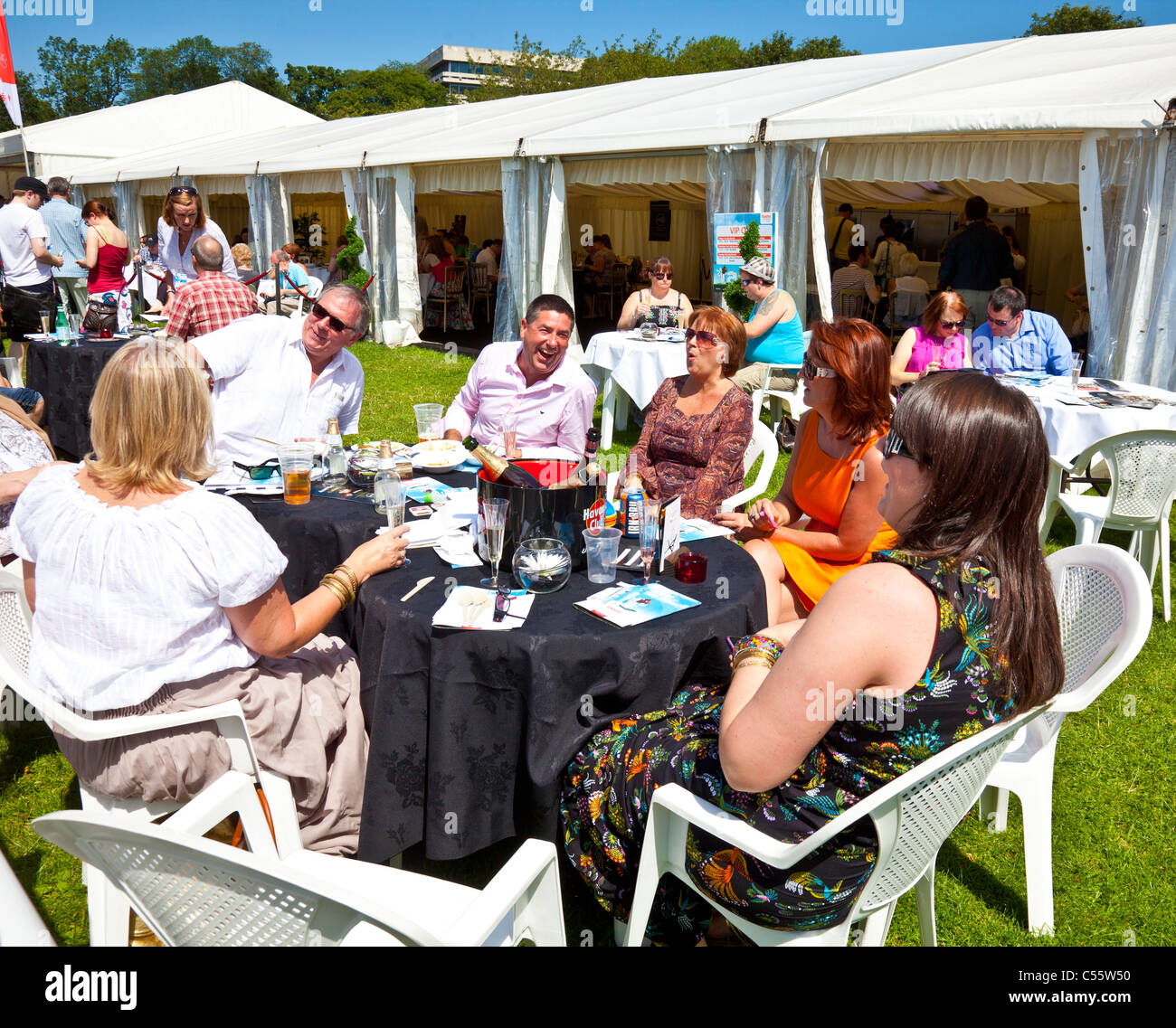 Group of people around a table in the VIP enclosure at the Taste of ...