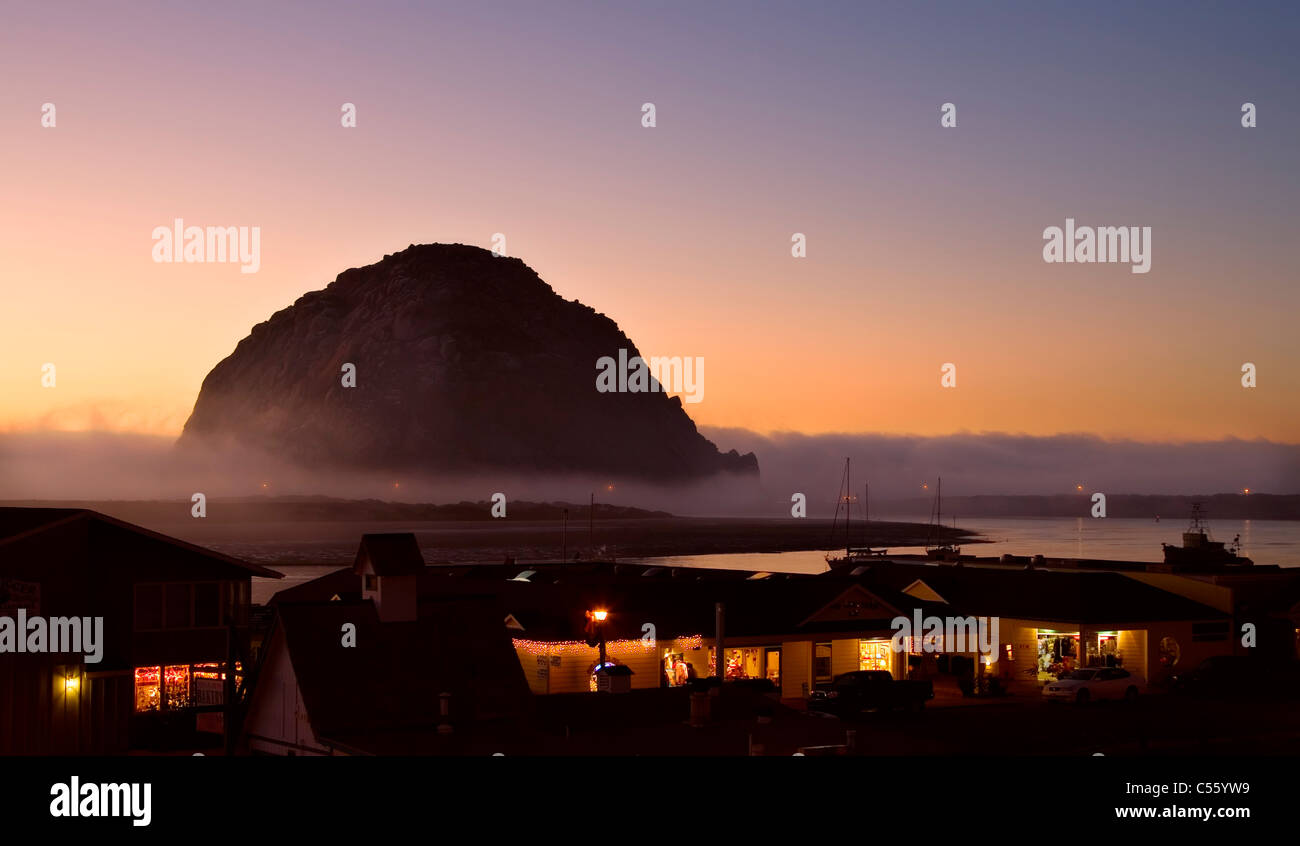 Stores with a cliff in the background, Morro Rock, Morro Bay ...