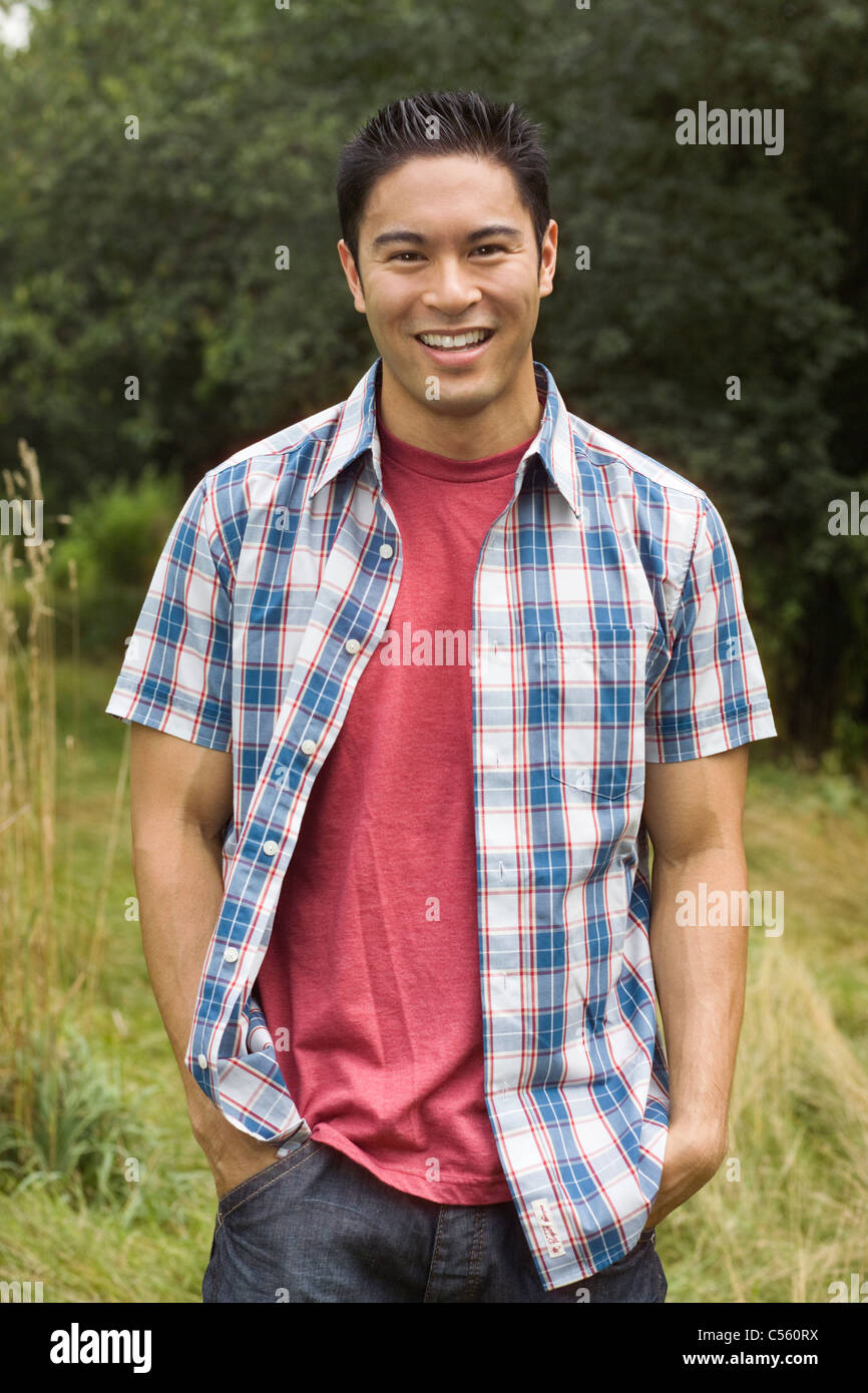 Mid adult man standing in a field Stock Photo - Alamy