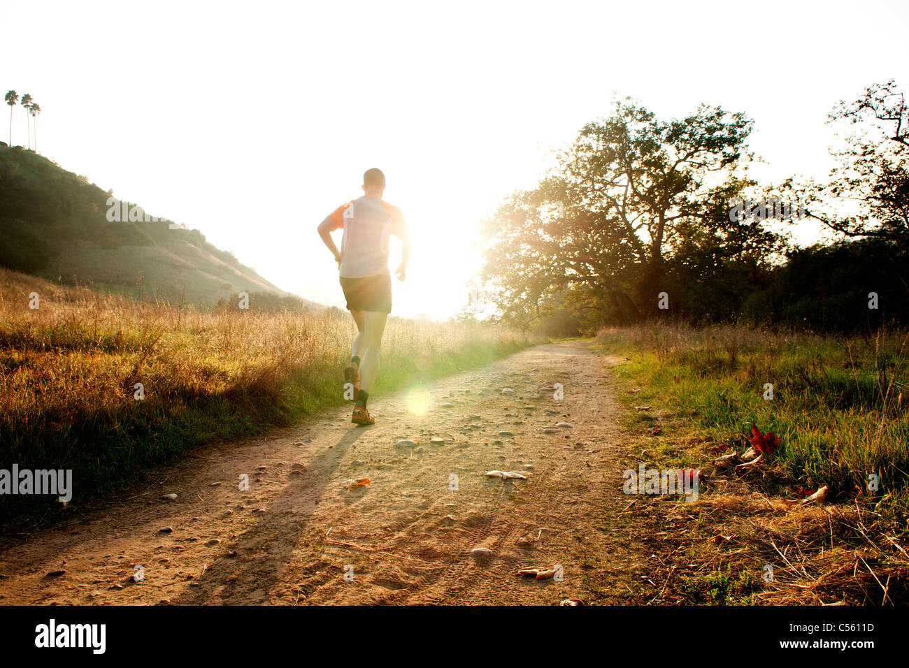 Man running at sunset in a park, San Clemente Canyon, San Diego County ...