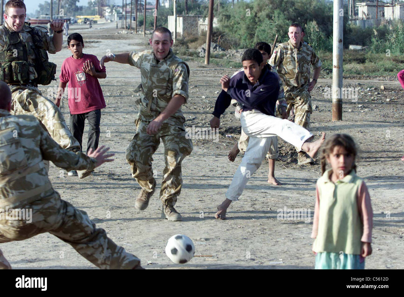 Soldiers from the Royal Regiment of Wales playing soccer with some ...