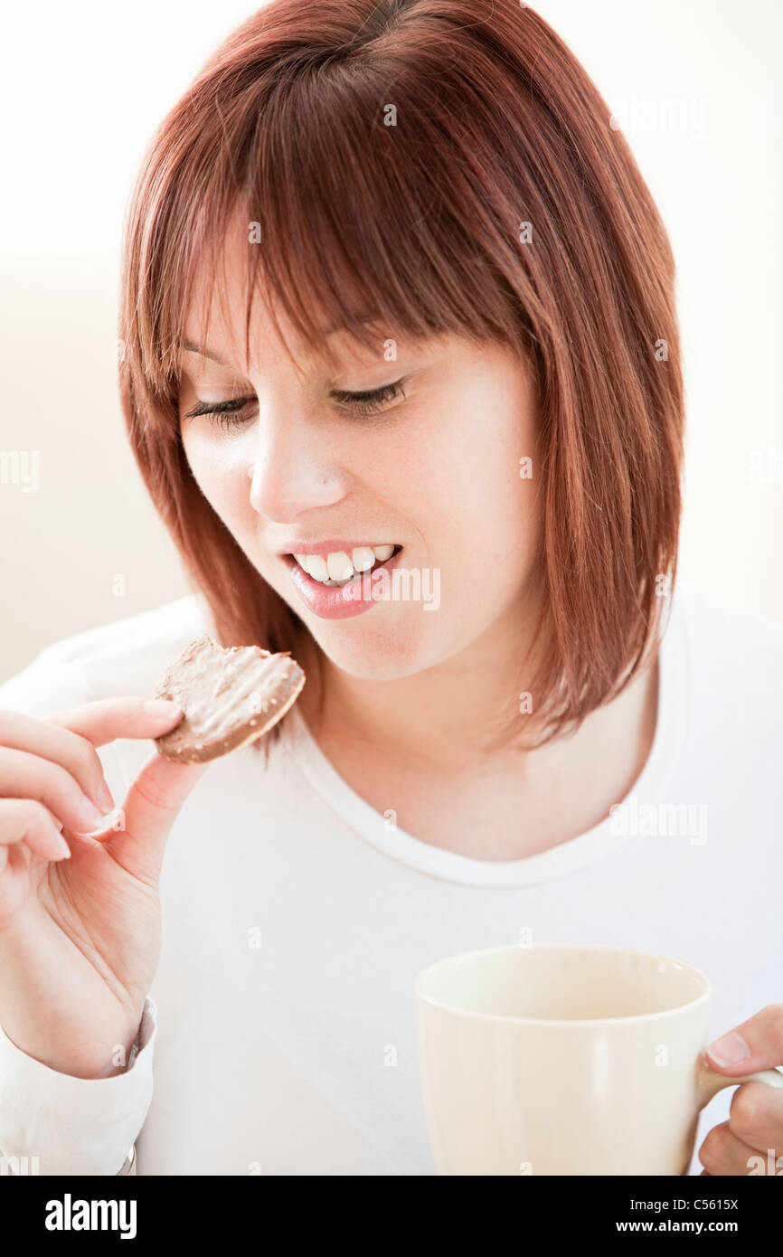 Biting into chocolate digestive biscuit hi-res stock photography and ...