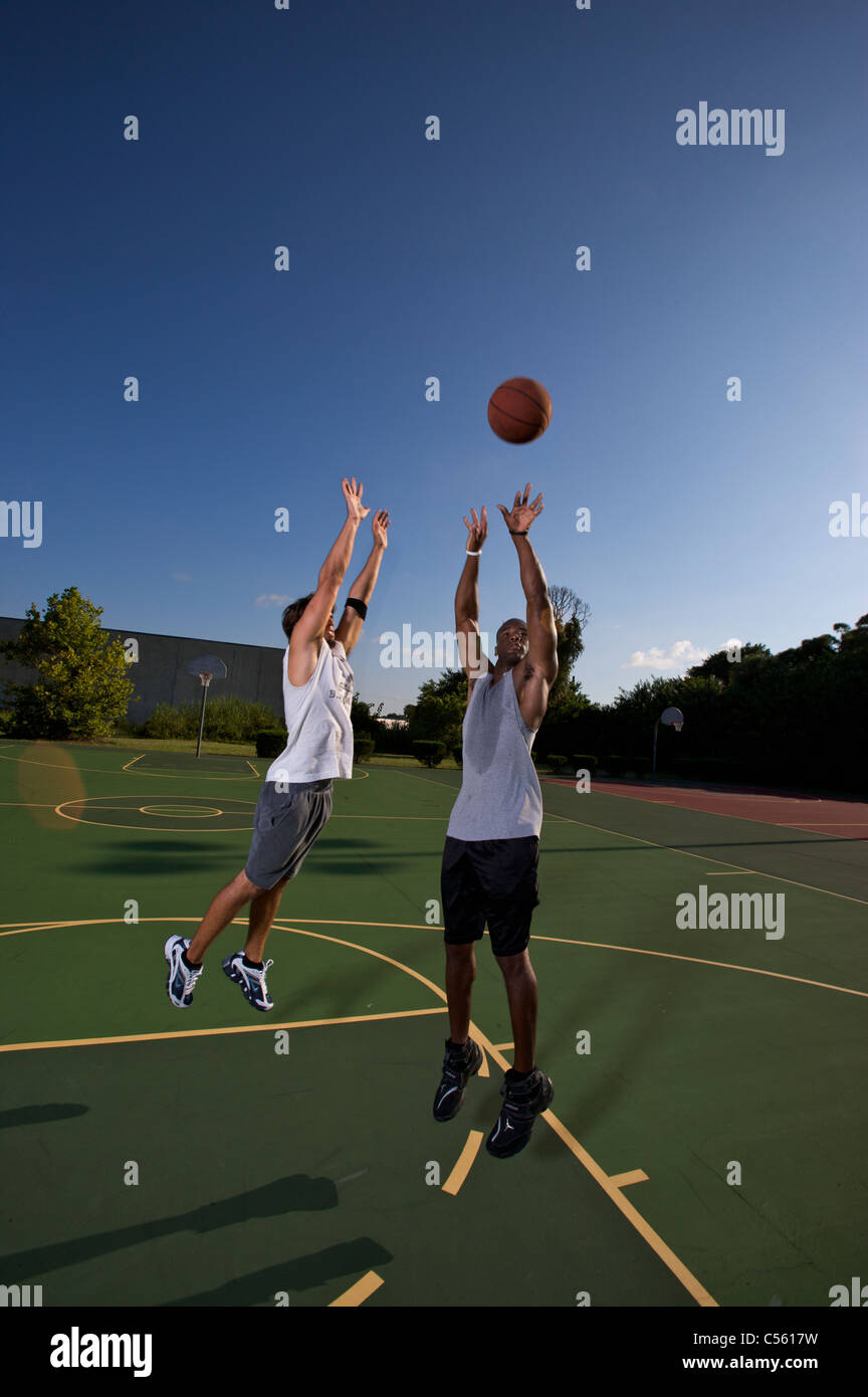 jump shot during two on two basketball game being defended Stock Photo ...