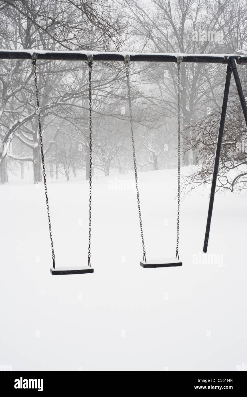 Swings in snow Stock Photo - Alamy