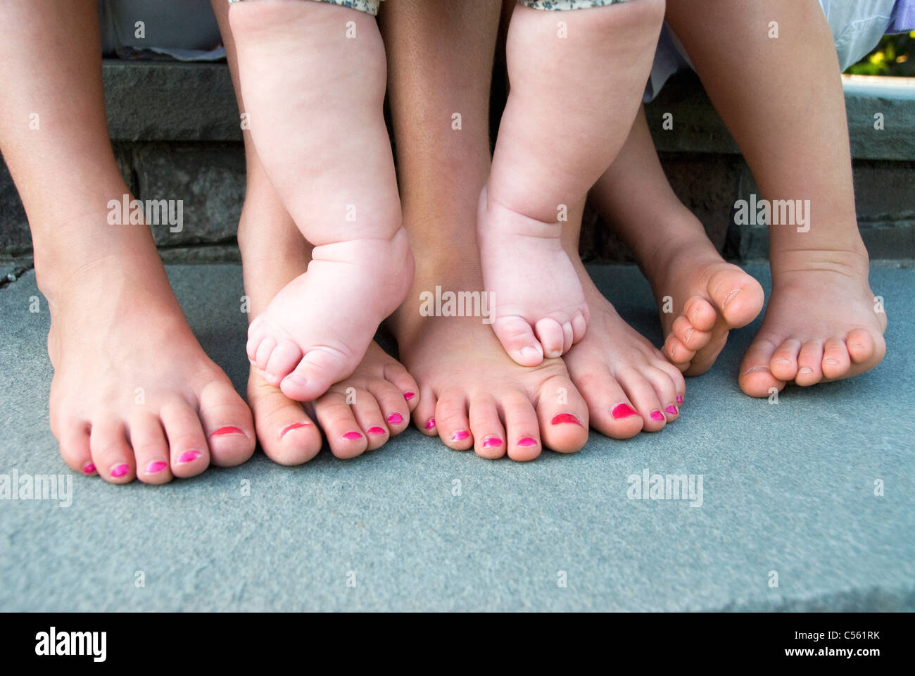 Close-up of feet of four children Stock Photo - Alamy