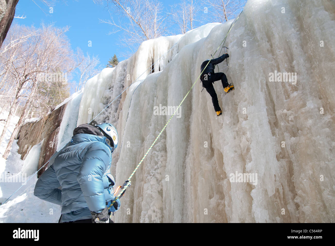 Husband and wife ice climbing team at Champney falls in the White ...