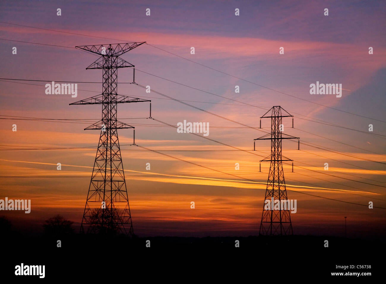 Power Lines And Electrical Towers In Silhouette Against A Vibrant ...